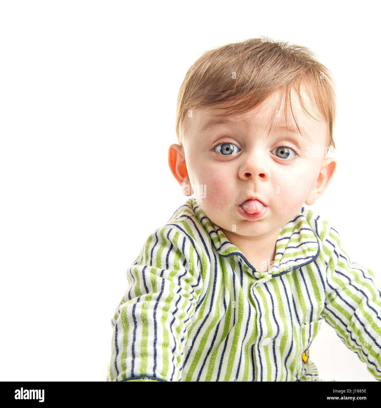 Baby grimacing to the camera on white background Stock Photo - Alamy
