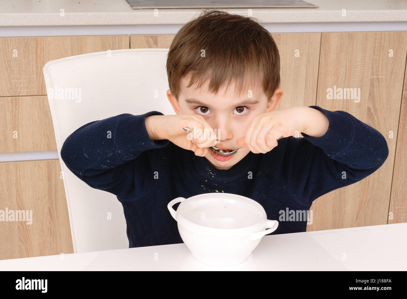 Happy little boy having healthy breakfast Stock Photo - Alamy