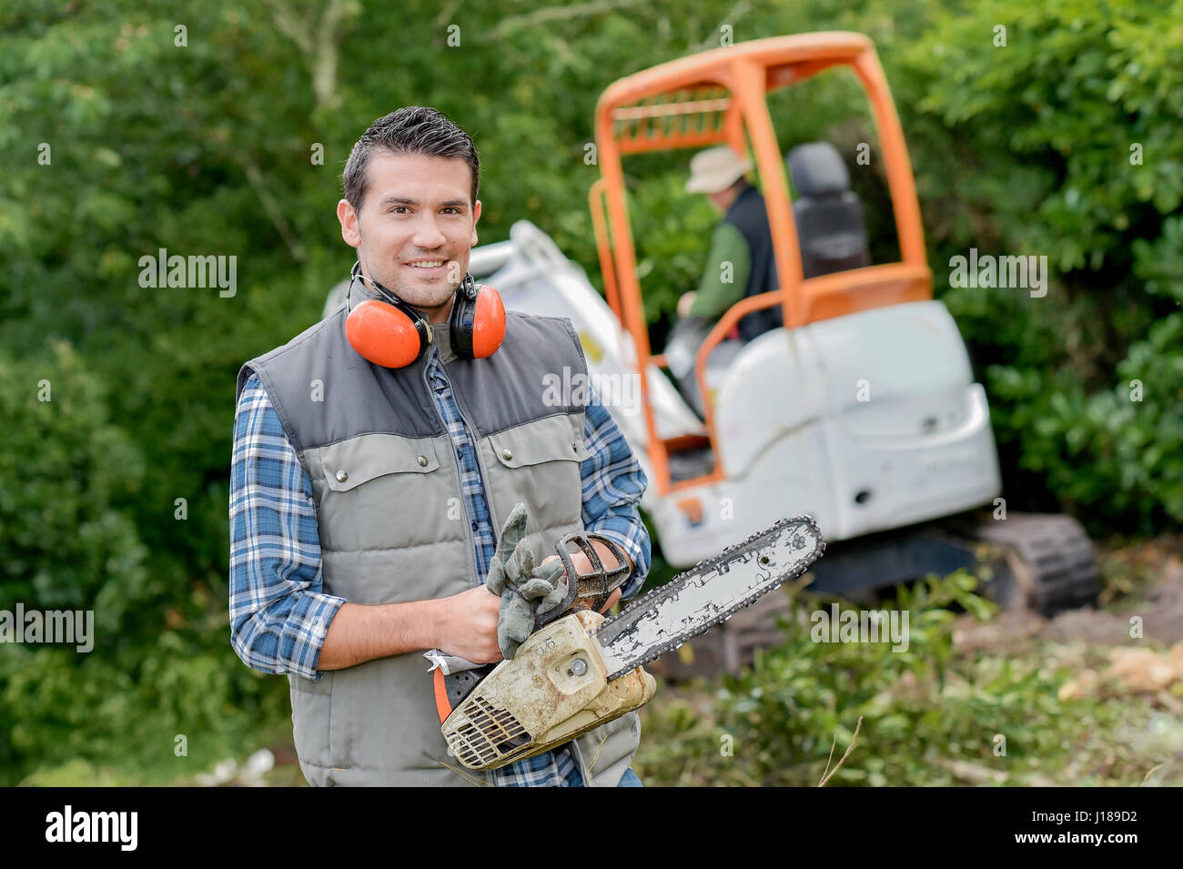 gardener with chainsaw Stock Photo - Alamy