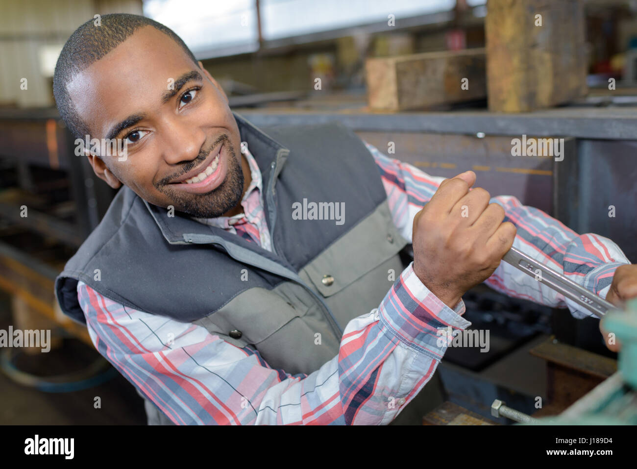 worker smiling and posing Stock Photo - Alamy