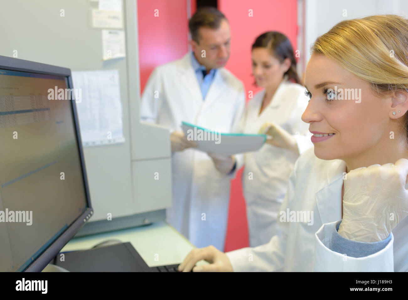 Lady smiling while using computer Stock Photo - Alamy