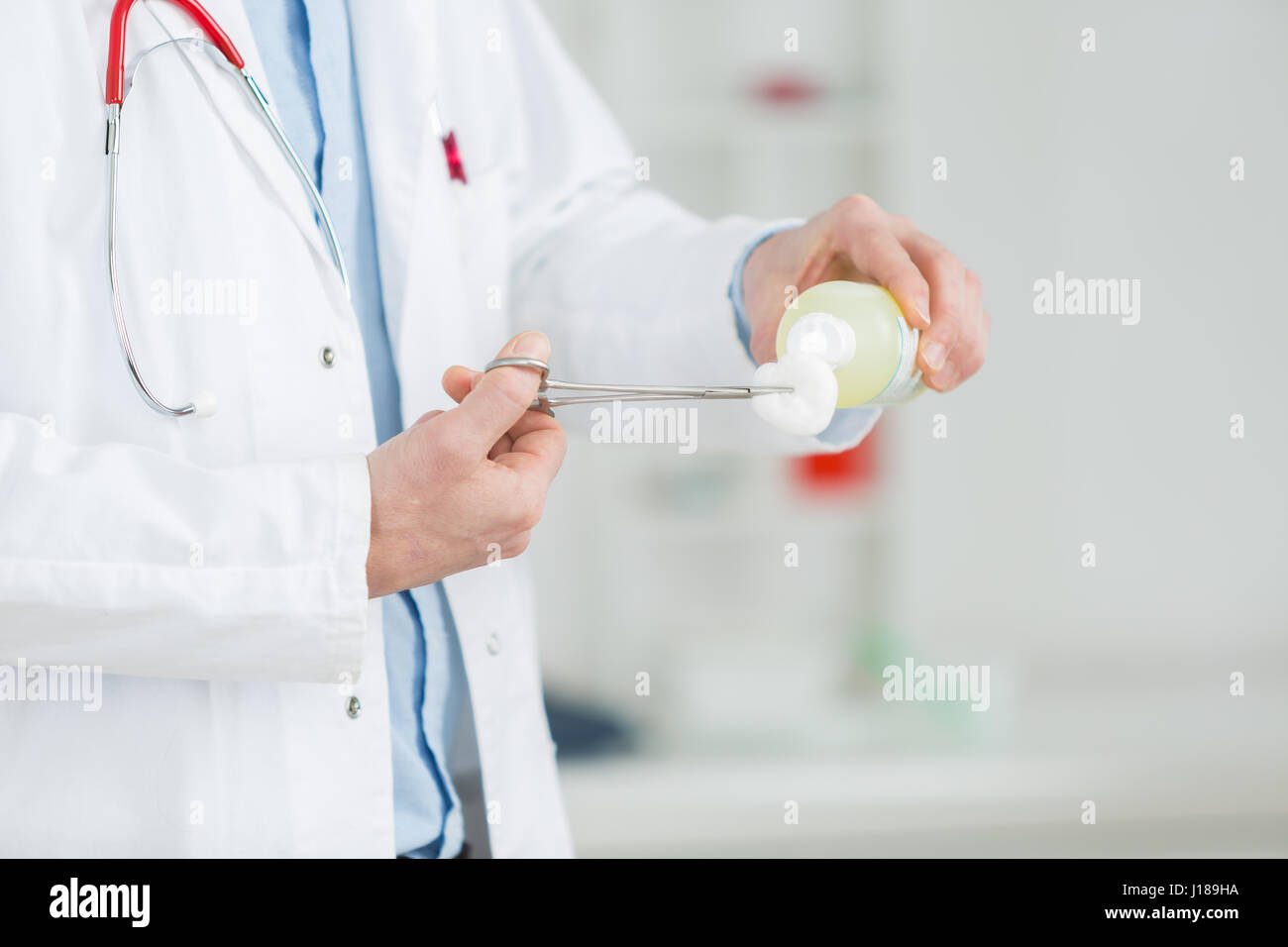 a medical doctor disinfecting pliers at the hospital Stock Photo - Alamy