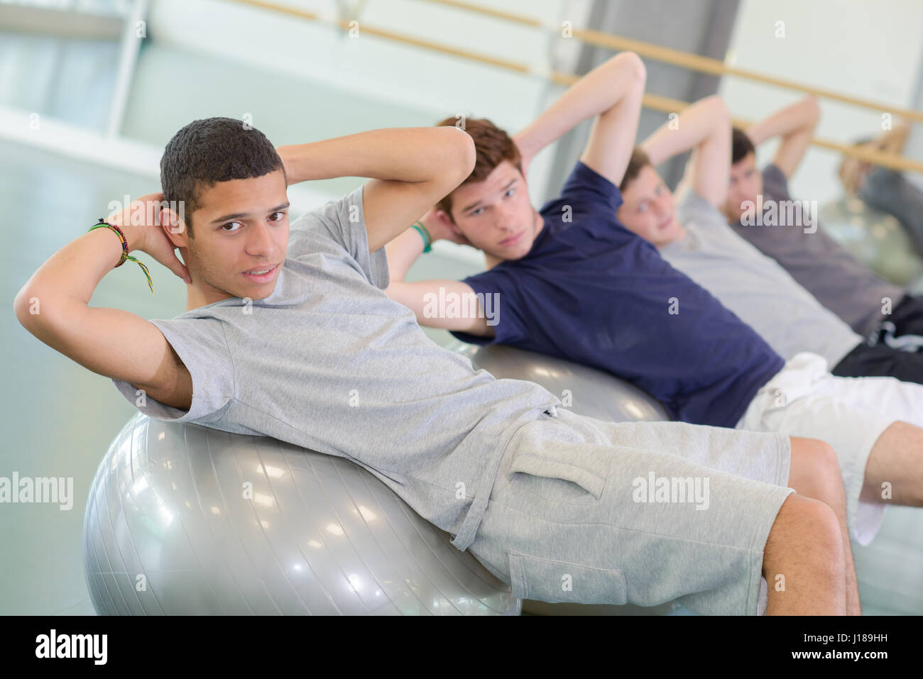 men on top of gym ball Stock Photo - Alamy
