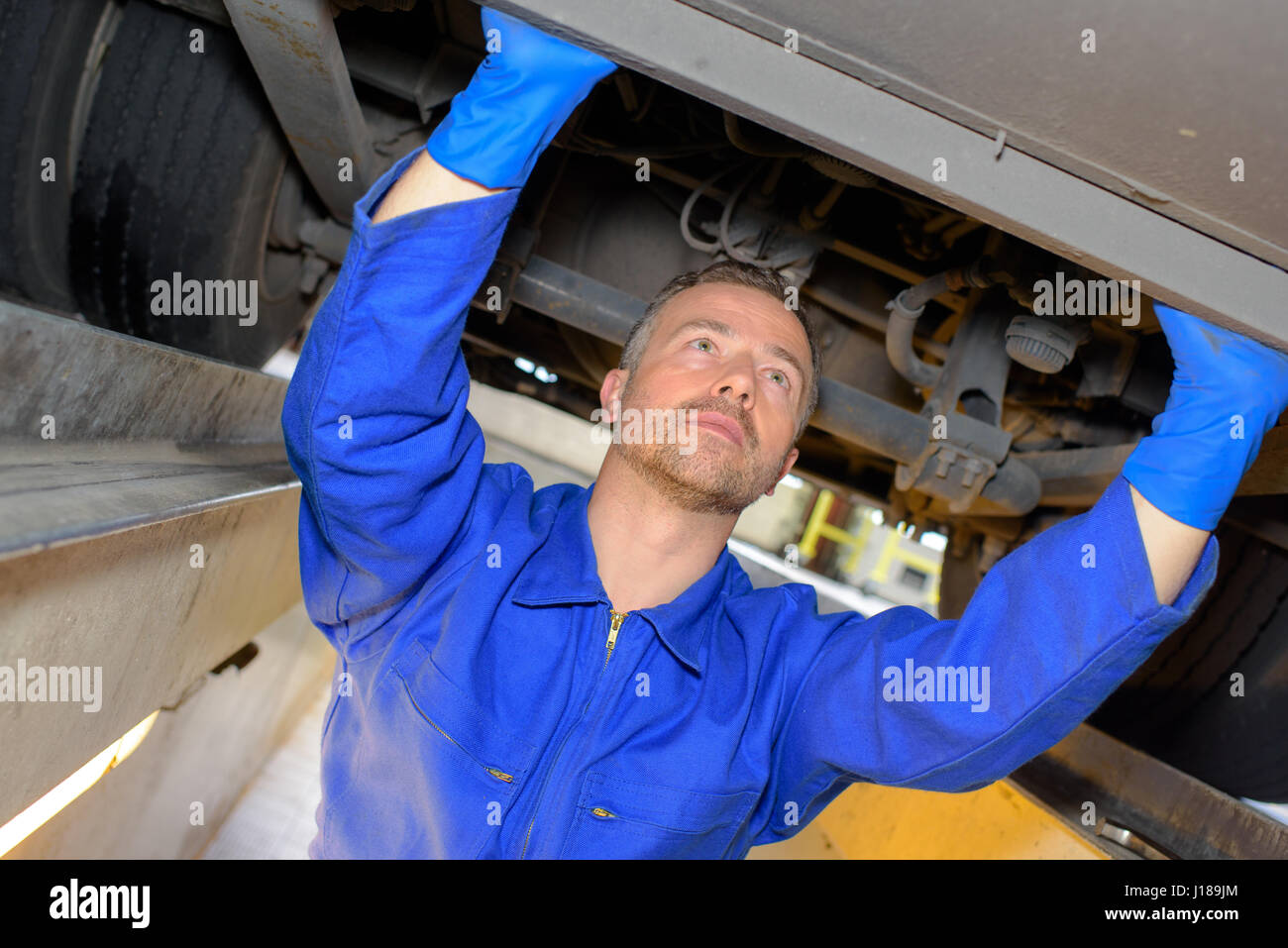 mechanic working in the garage Stock Photo - Alamy