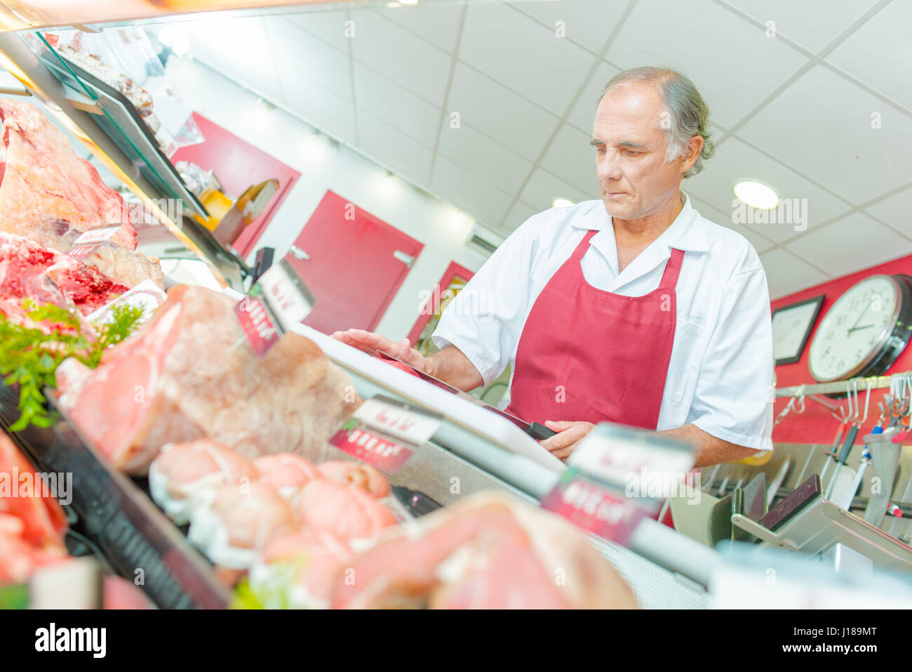 the butcher and the meat Stock Photo - Alamy