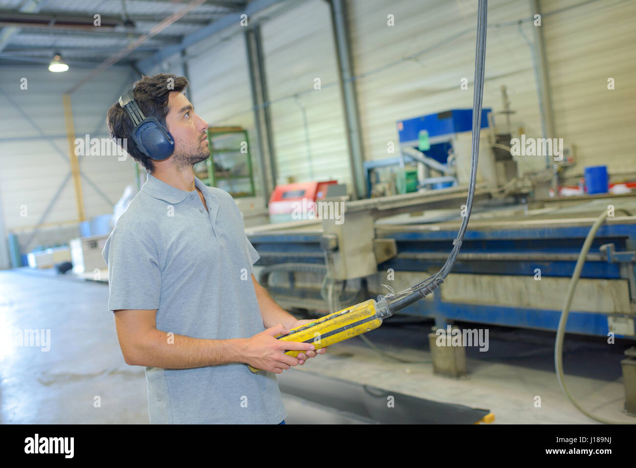 Man operating factory machinery Stock Photo - Alamy