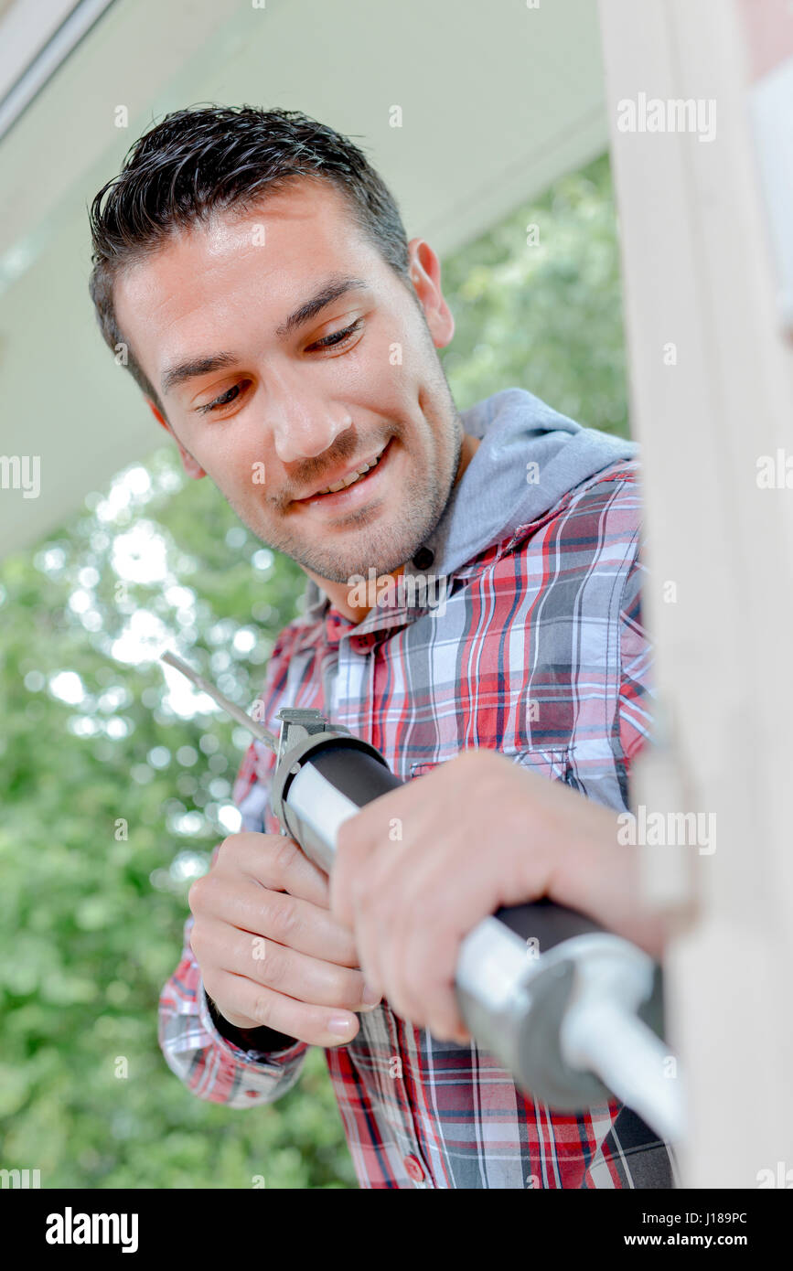 man putting in windows Stock Photo - Alamy