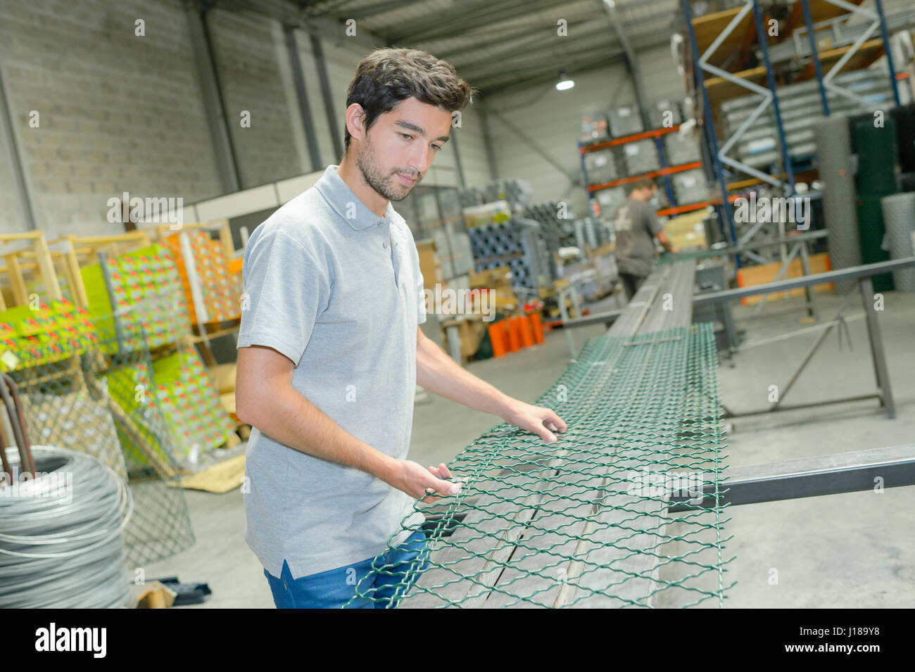 Male factory worker producing fencing Stock Photo - Alamy