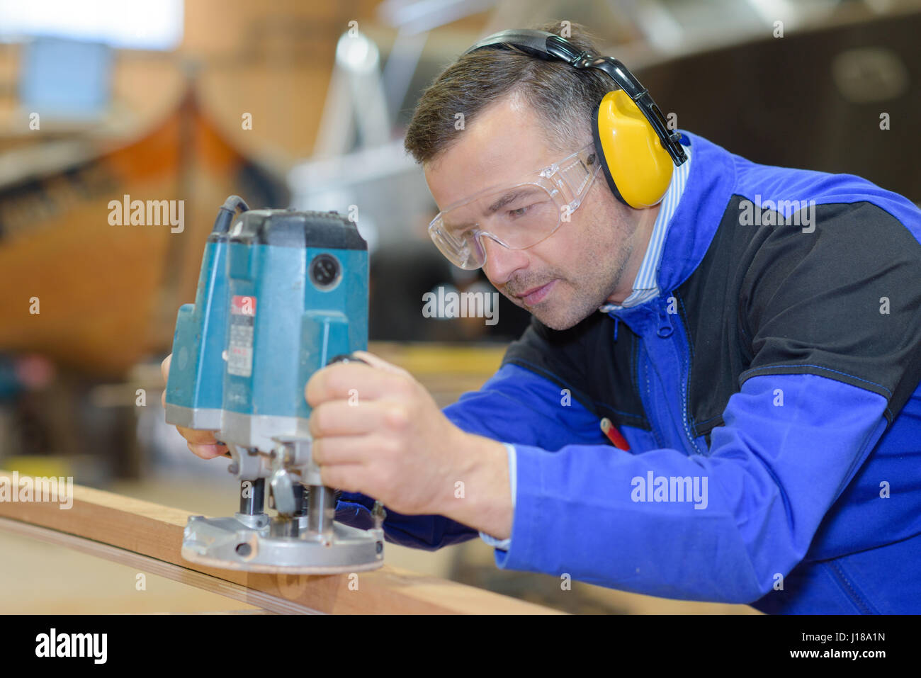 Carpenter using router Stock Photo - Alamy
