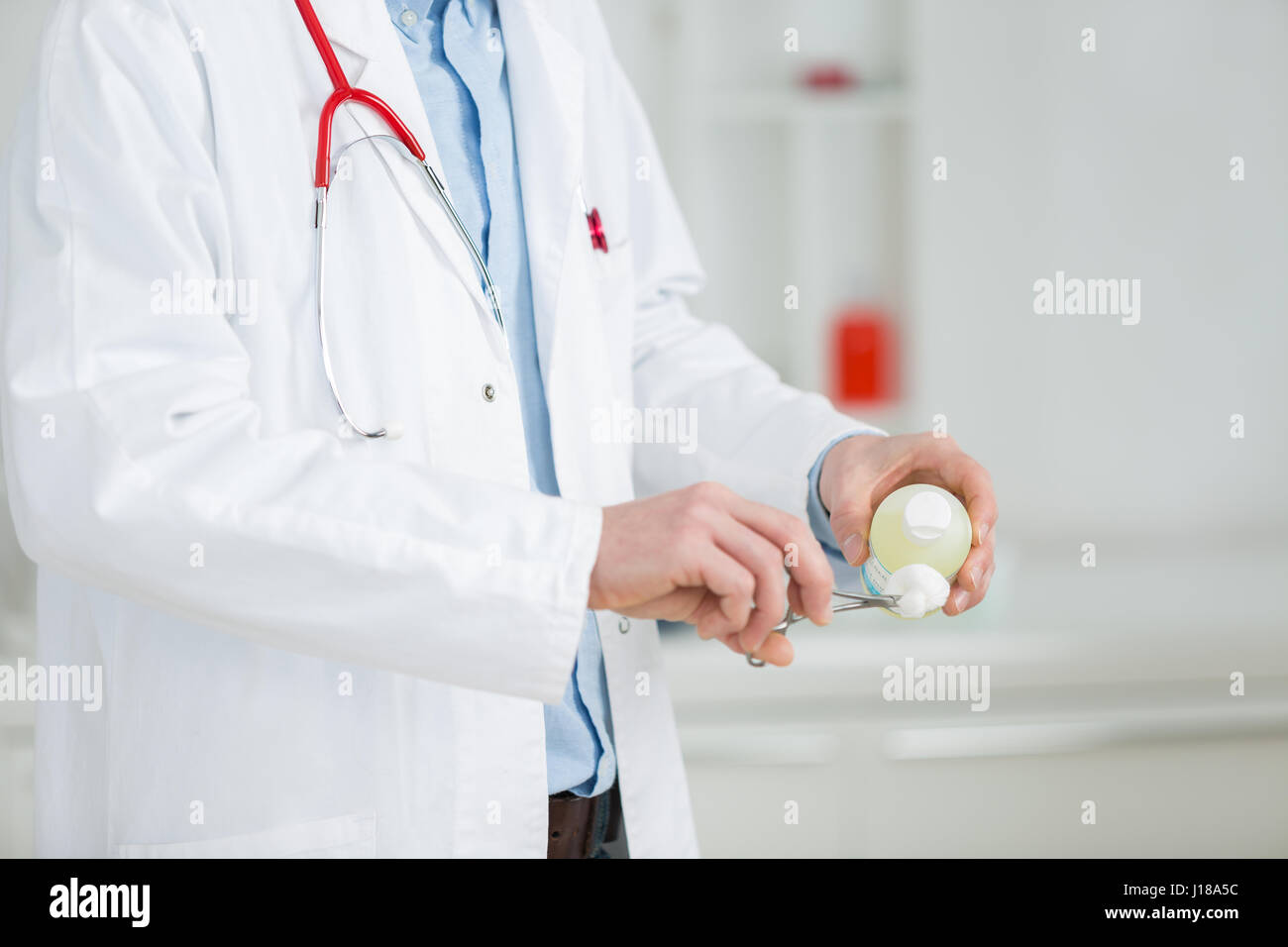 a medical doctor disinfecting pliers at the hospital Stock Photo - Alamy