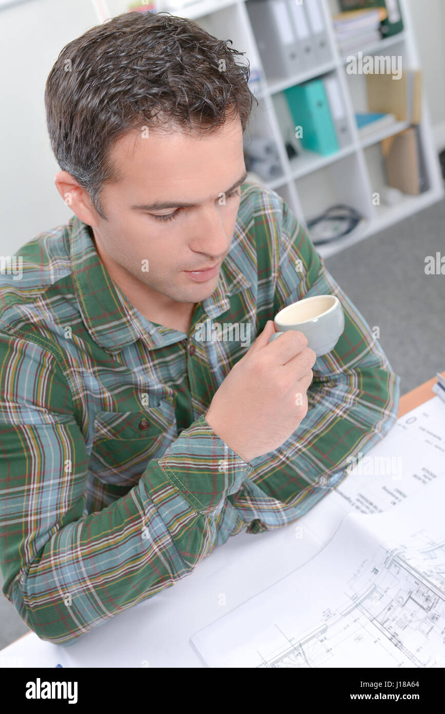 Employee drinking coffee Stock Photo - Alamy