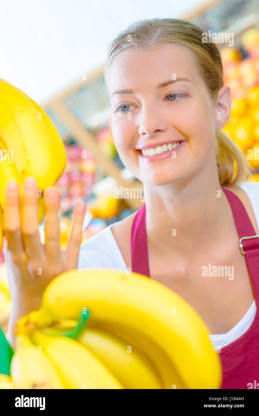 Shop assistant holding bunch bananas Stock Photo - Alamy Shop assistant holding bunch bananas Stock Photo - Alamy