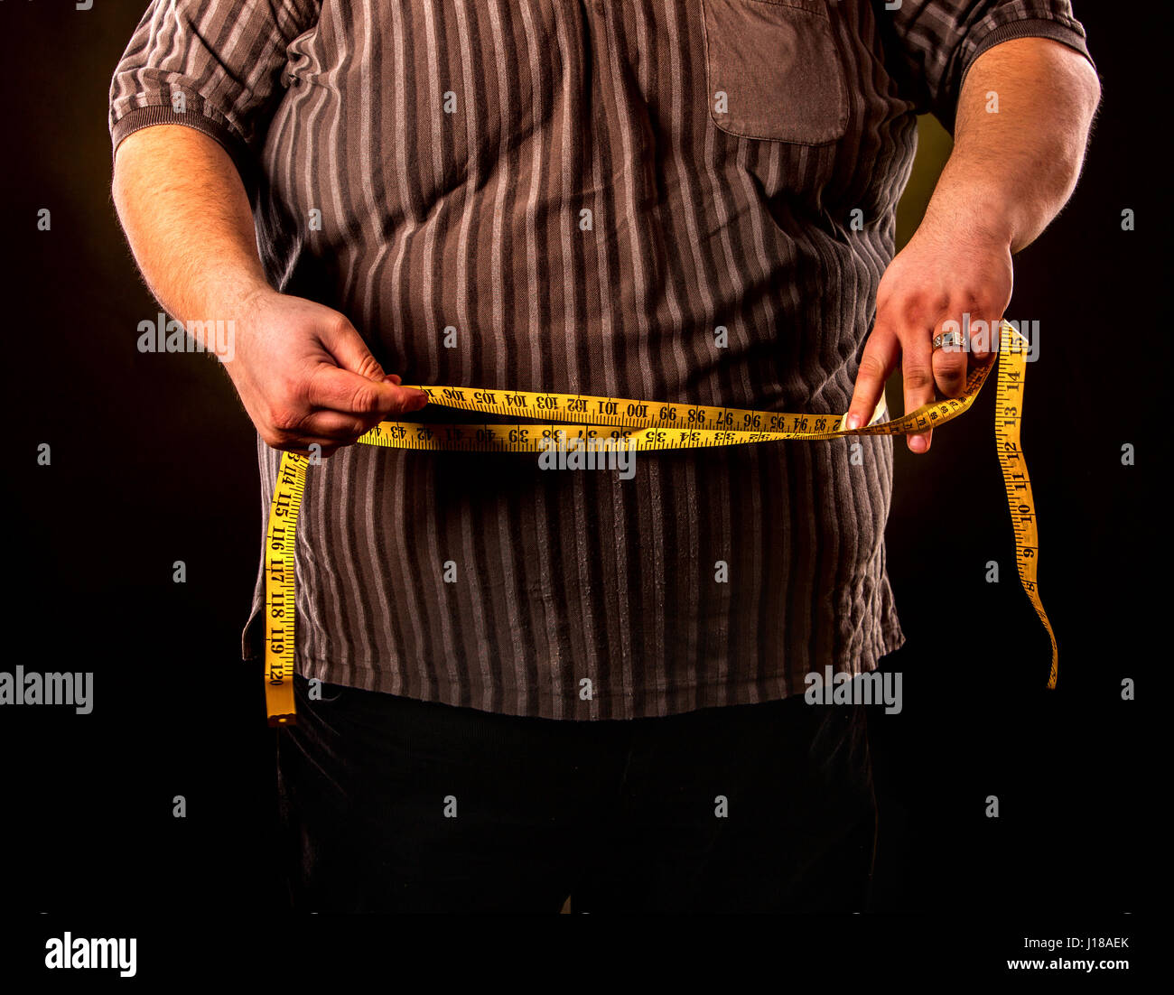 Overweight boy tape measure hi-res stock photography and images - Alamy