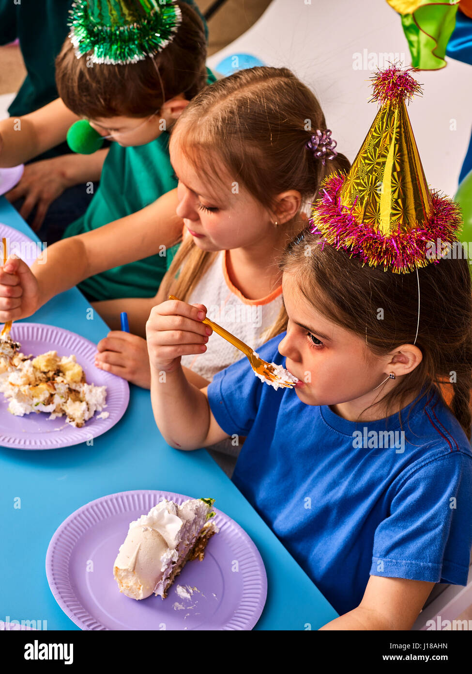 Birthday children celebrate party and eating cake on plate together ...