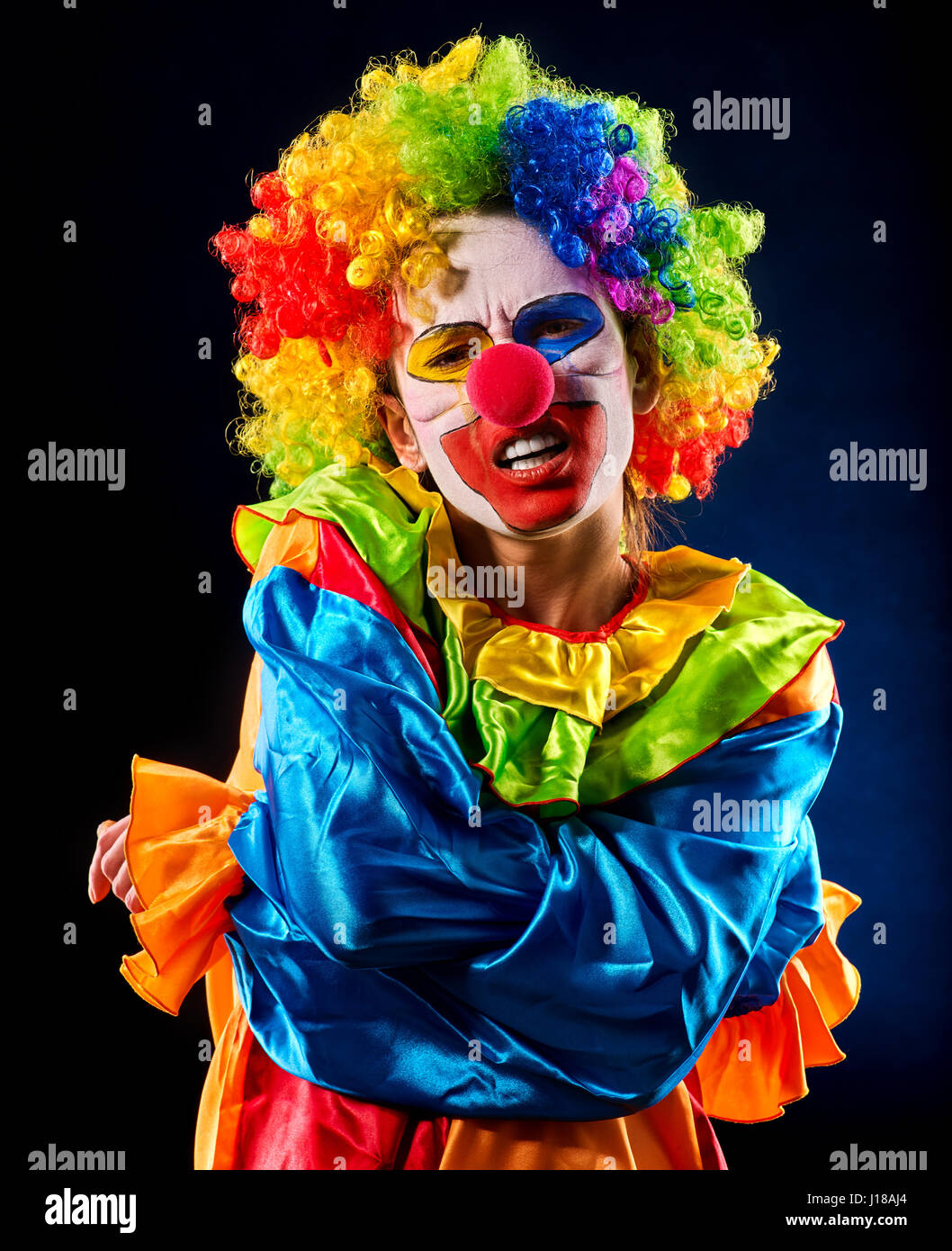 Sad clown on black background. Sick woman holds to stomach Stock Photo ...