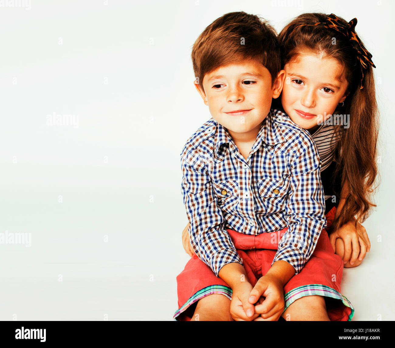 little cute boy and girl hugging playing on white background, ha Stock Photo - Alamy