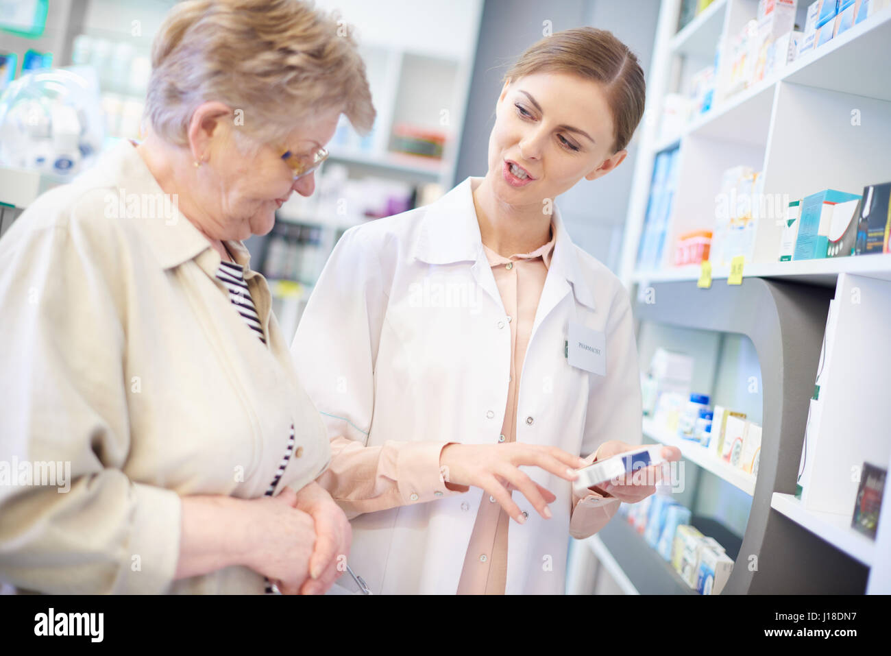 Professional pharmacist explaining prescription Stock Photo - Alamy