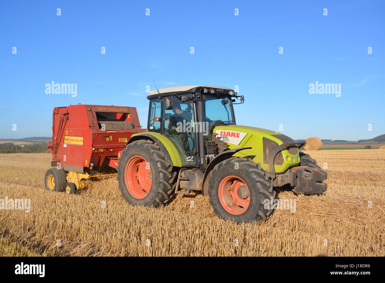 Claas Axon 340 Tractor with baler Stock Photo - Alamy