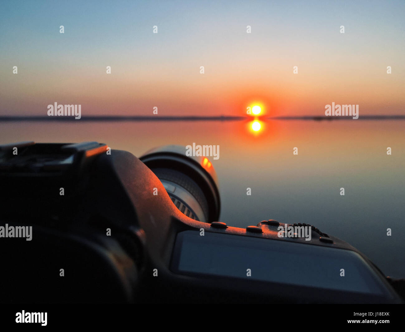 camera on background of a beautiful sunset. take a photo by camera ...
