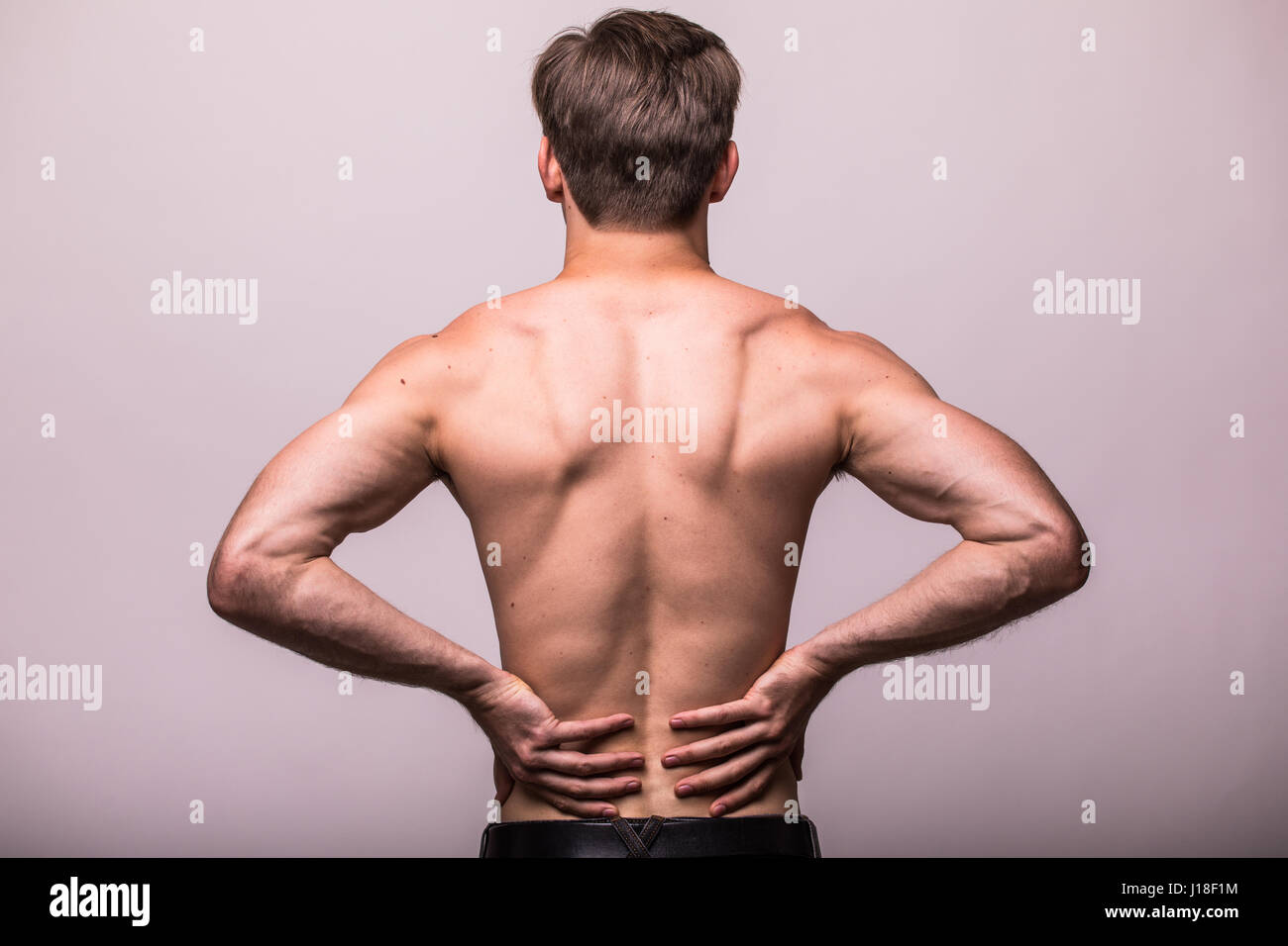 Close up of man rubbing his painful back. Pain relief, chiropractic ...
