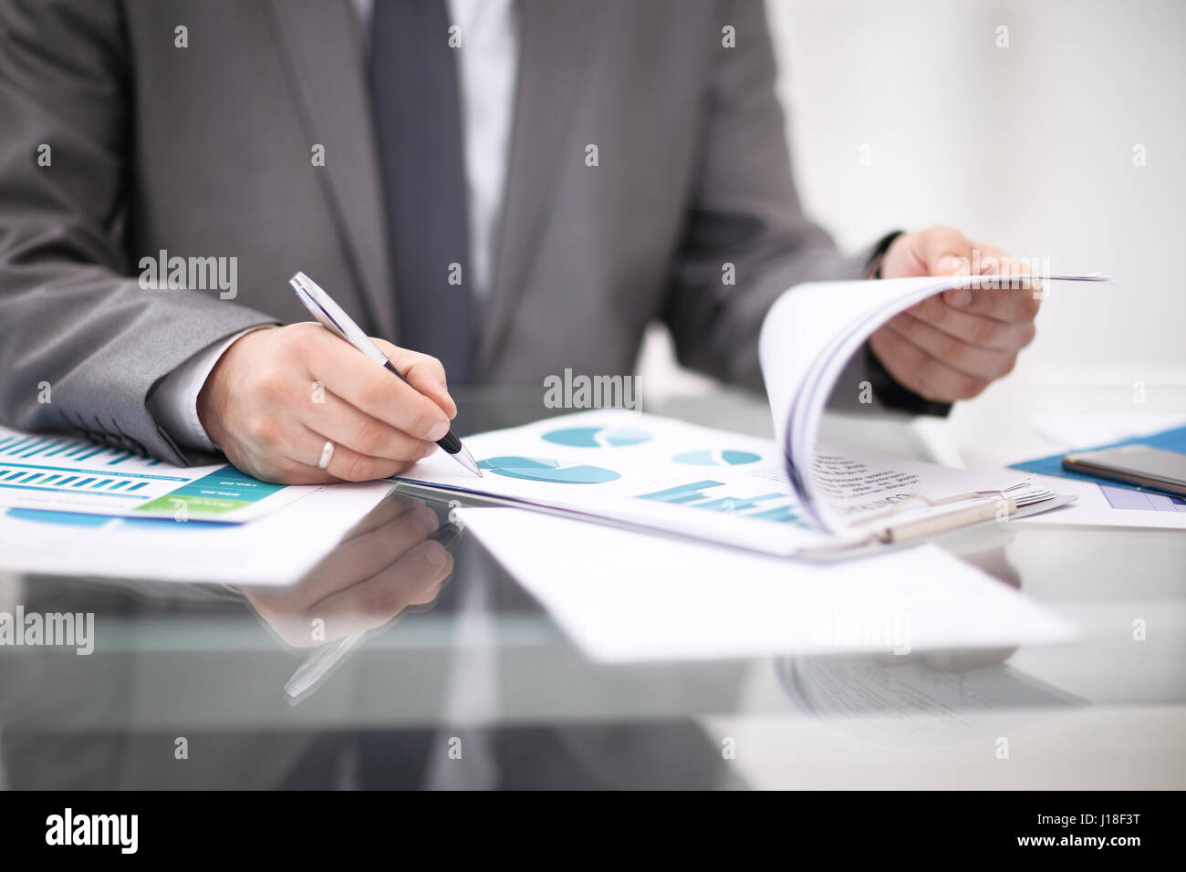 Image of business documents on workplace with partners interacting on ...