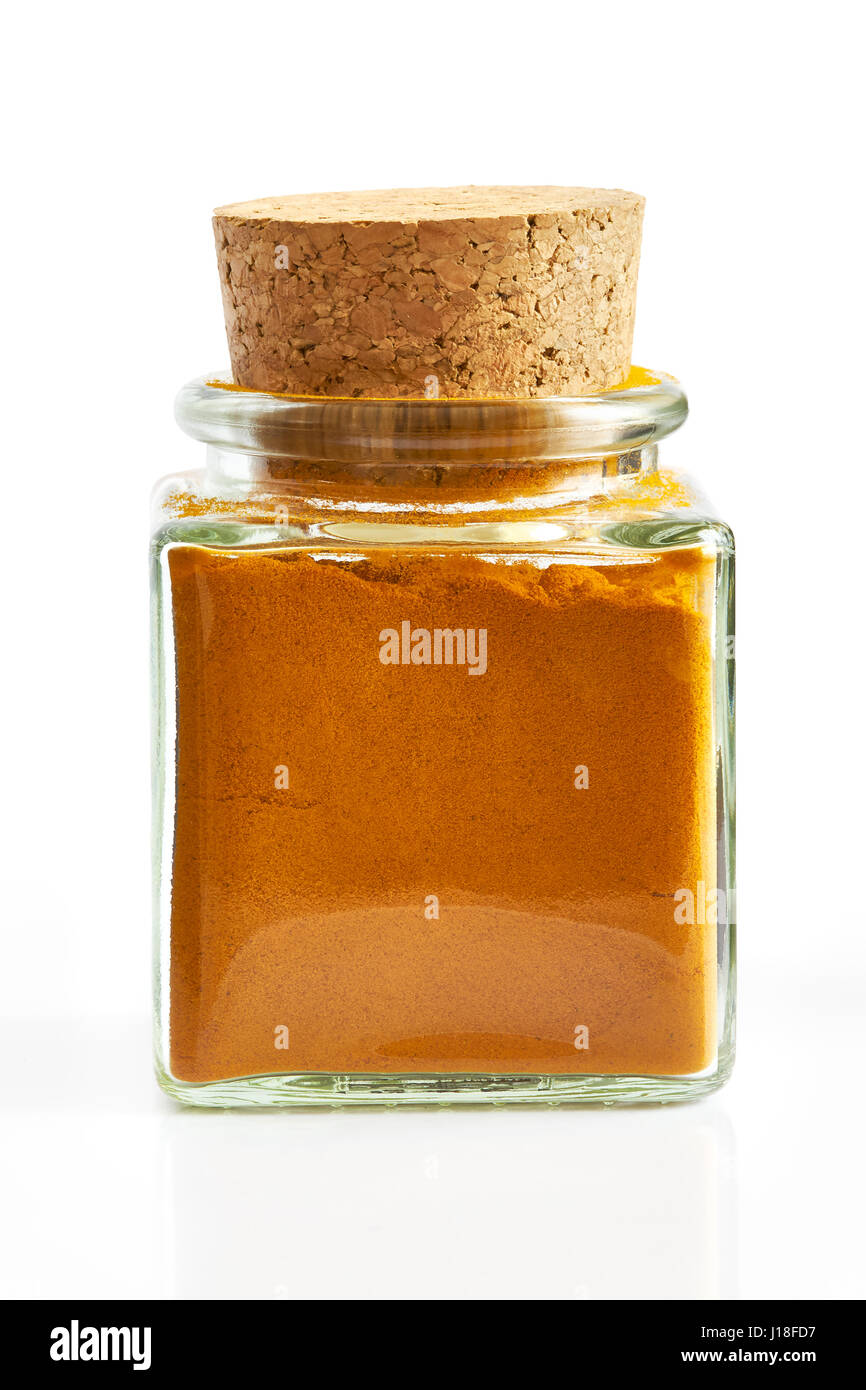 Turmeric powder in glass spice jar with wooden cork, isolated on white ...