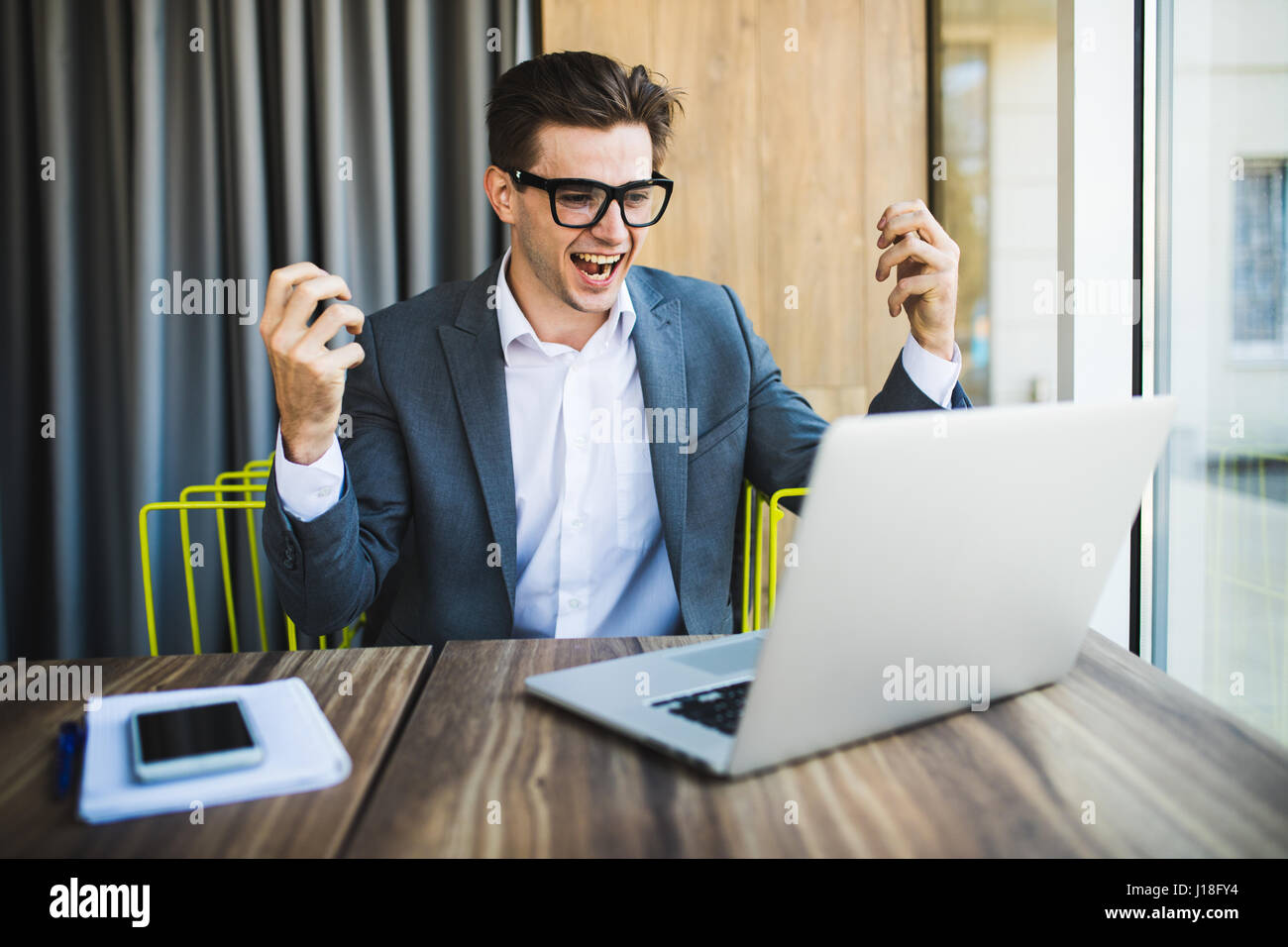 Happy businessman achiving his goal and showing fists Stock Photo - Alamy