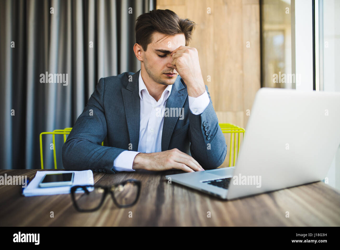 Young businessman stressed jobs headaches about the job on table Stock ...
