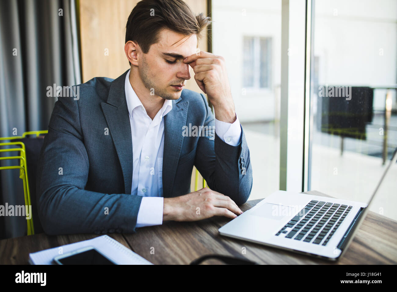 frustrated business man working on laptop computer at office Stock ...