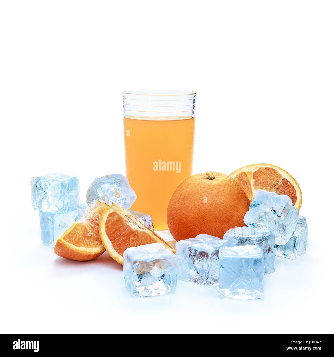 Glass of cool orange juice, ice and orange slices in he composition ...