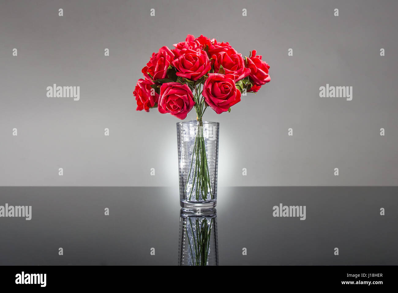 Red roses over a glossy surface Stock Photo - Alamy