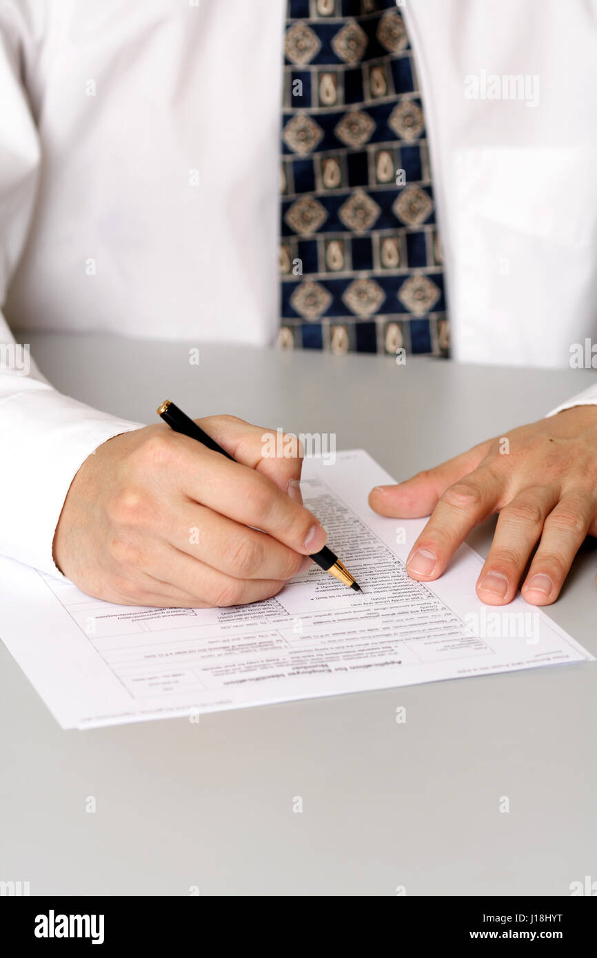 A business man filling out a form Stock Photo - Alamy