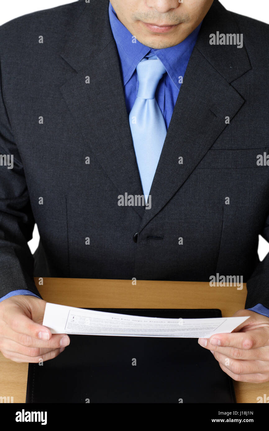 Businessman reading a letter Stock Photo - Alamy
