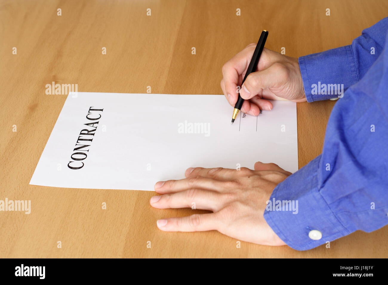 A businessman signing a contract or an agreement Stock Photo - Alamy