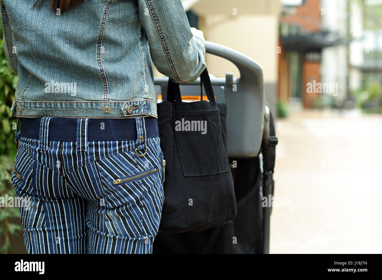A woman pushing a stroller in a shopping mall Stock Photo - Alamy