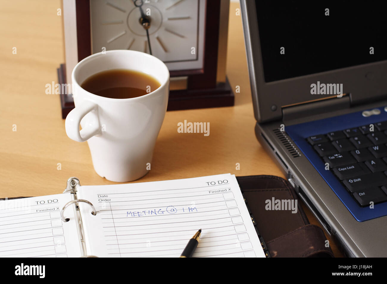Meeting reminder in a business planner Stock Photo - Alamy
