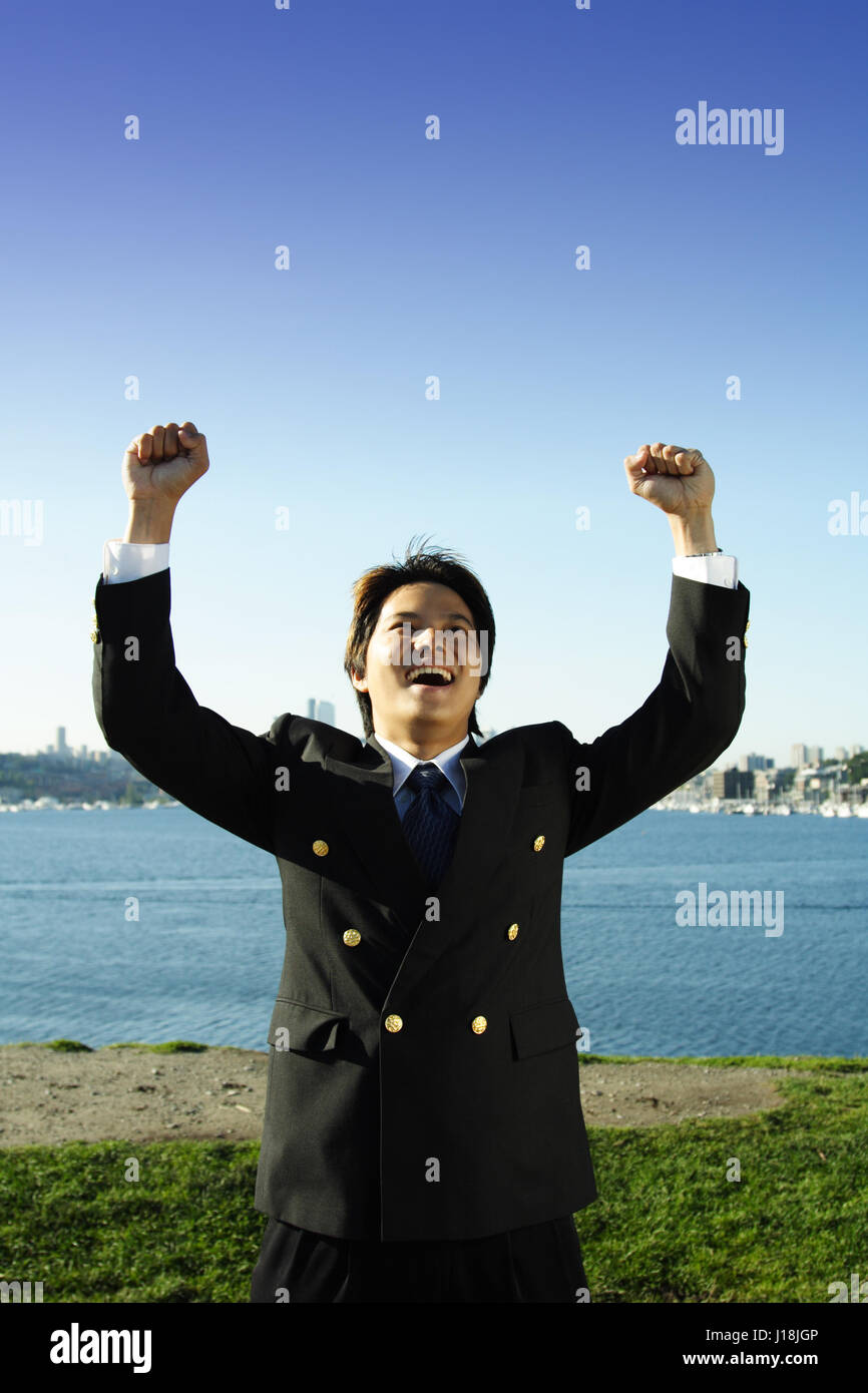 Happy businessman with two arms up in the air Stock Photo - Alamy