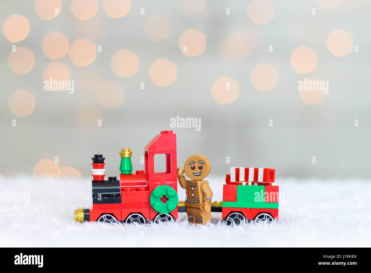 Lego gingerbread man standing in front of a train in the snow with a ...