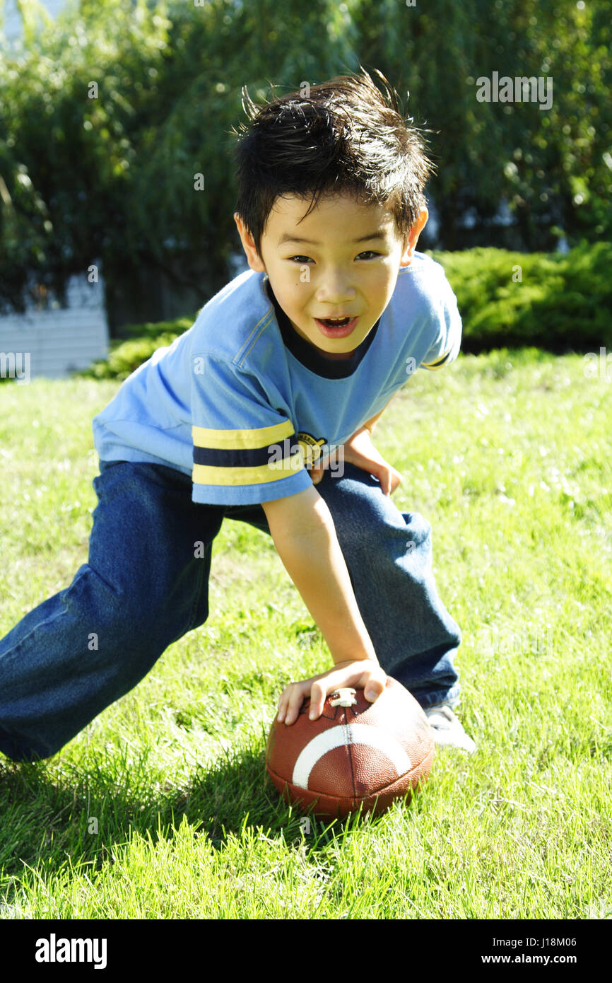 A boy having fun playing football Stock Photo - Alamy