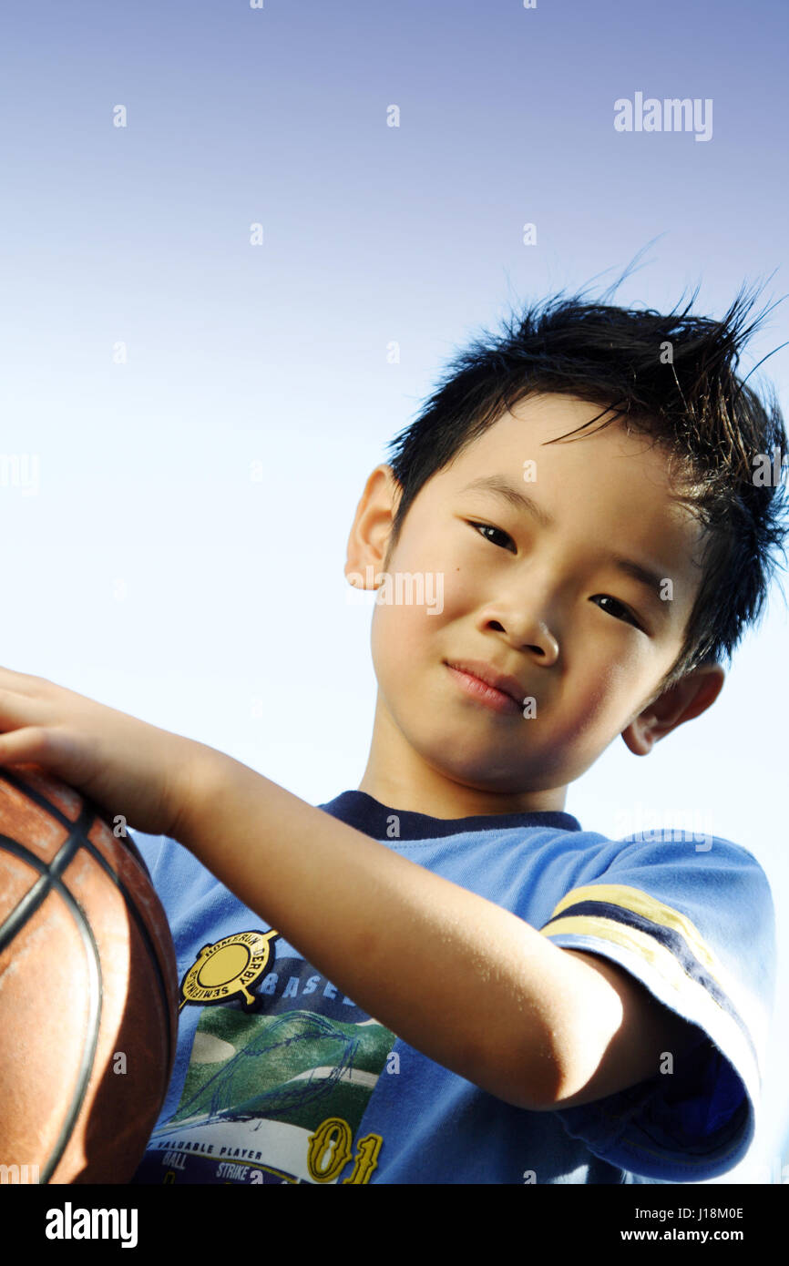 A boy playing basketball outside Stock Photo - Alamy