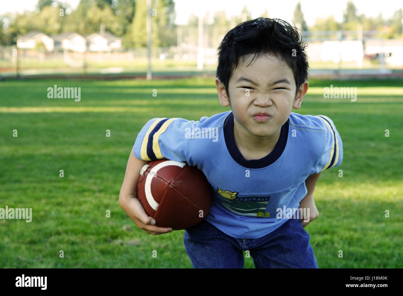 A boy playing football outdoor Stock Photo - Alamy