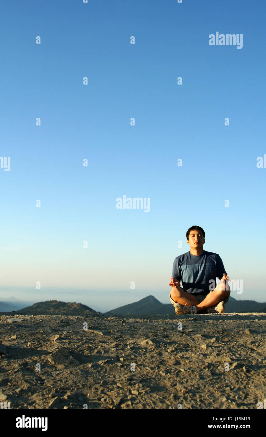 Man meditating on mountain top hi-res stock photography and images - Alamy