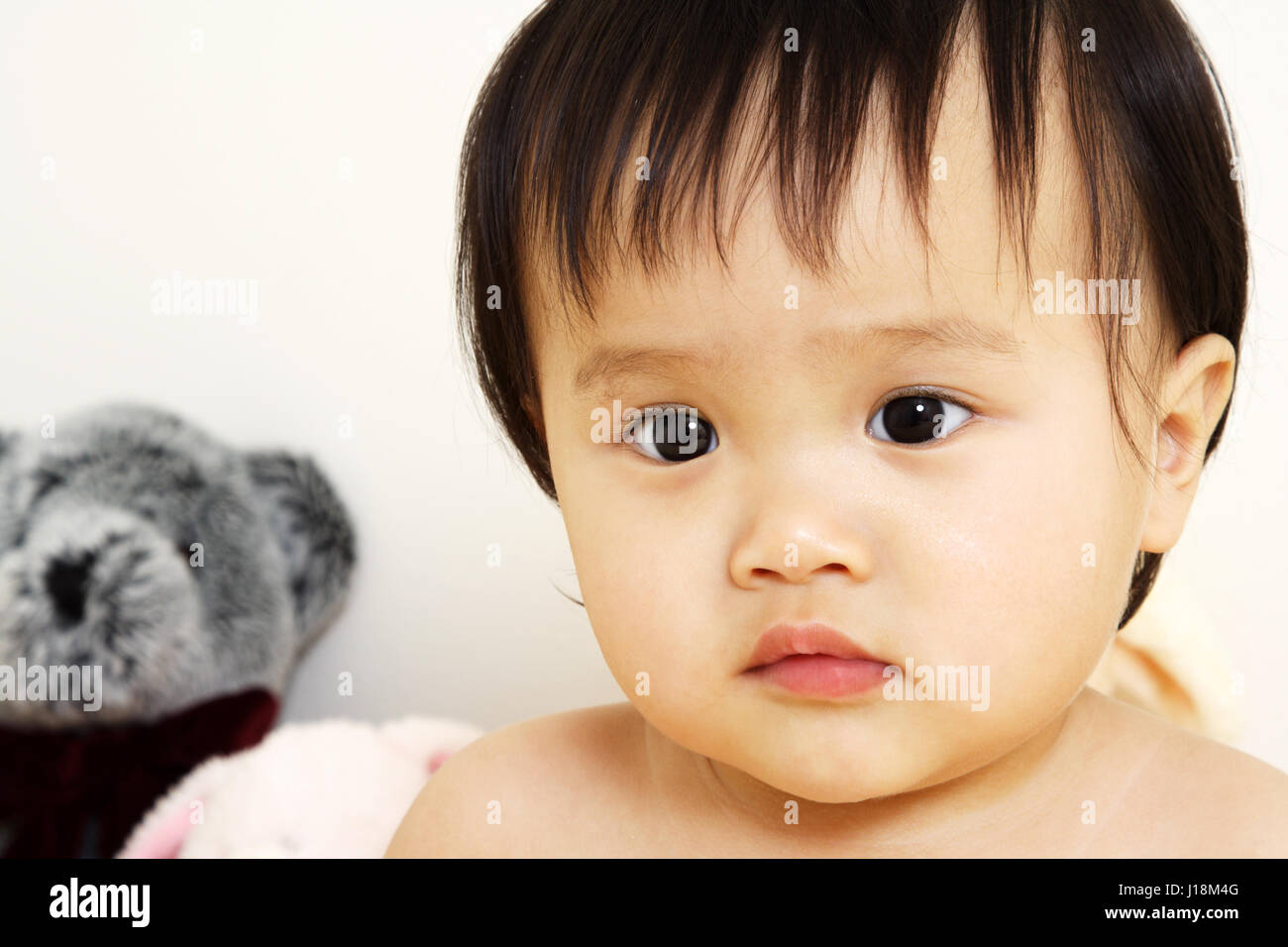 Little cute baby girl staring Stock Photo - Alamy