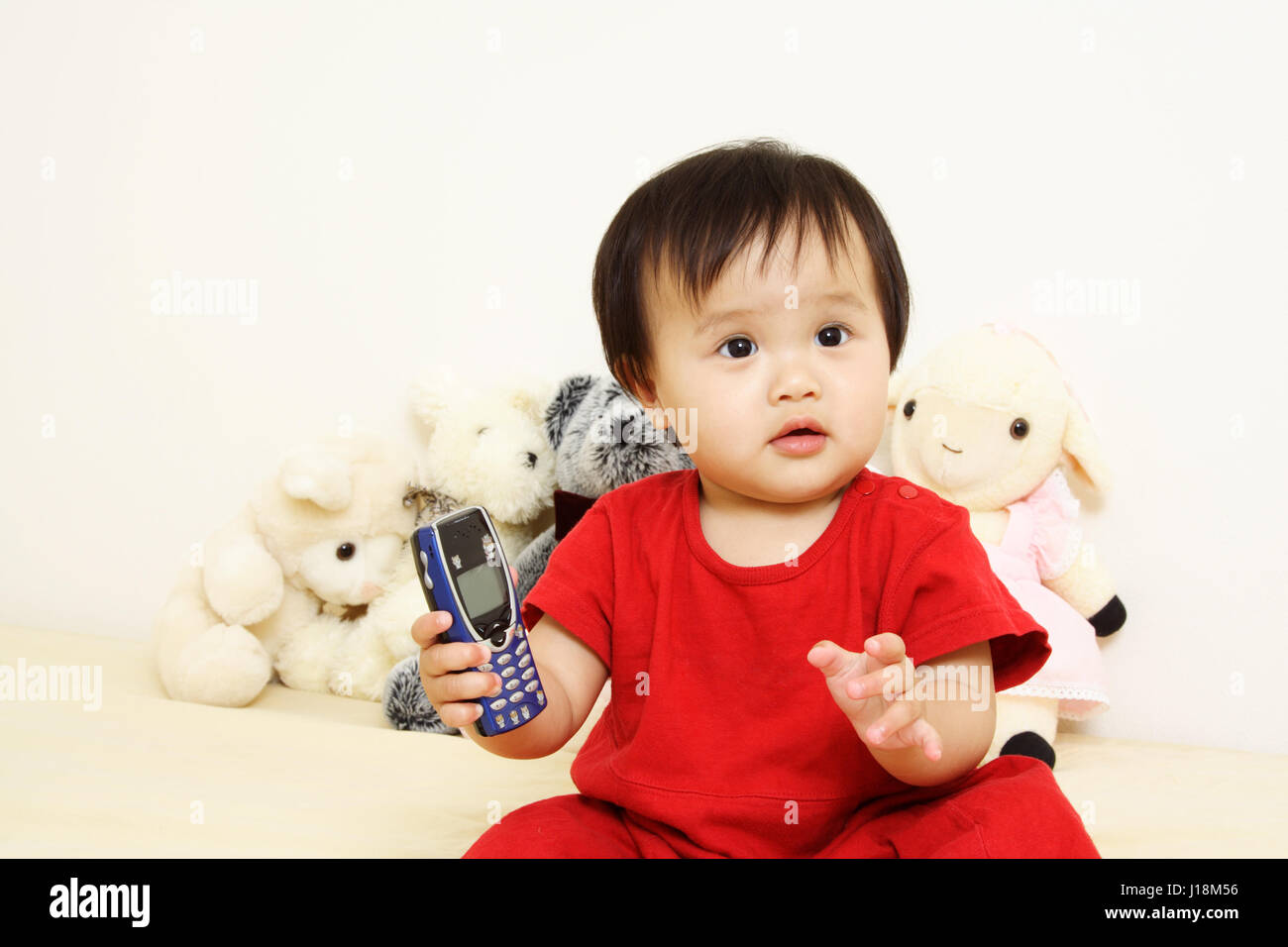 A cute little baby girl with cell phone Stock Photo - Alamy