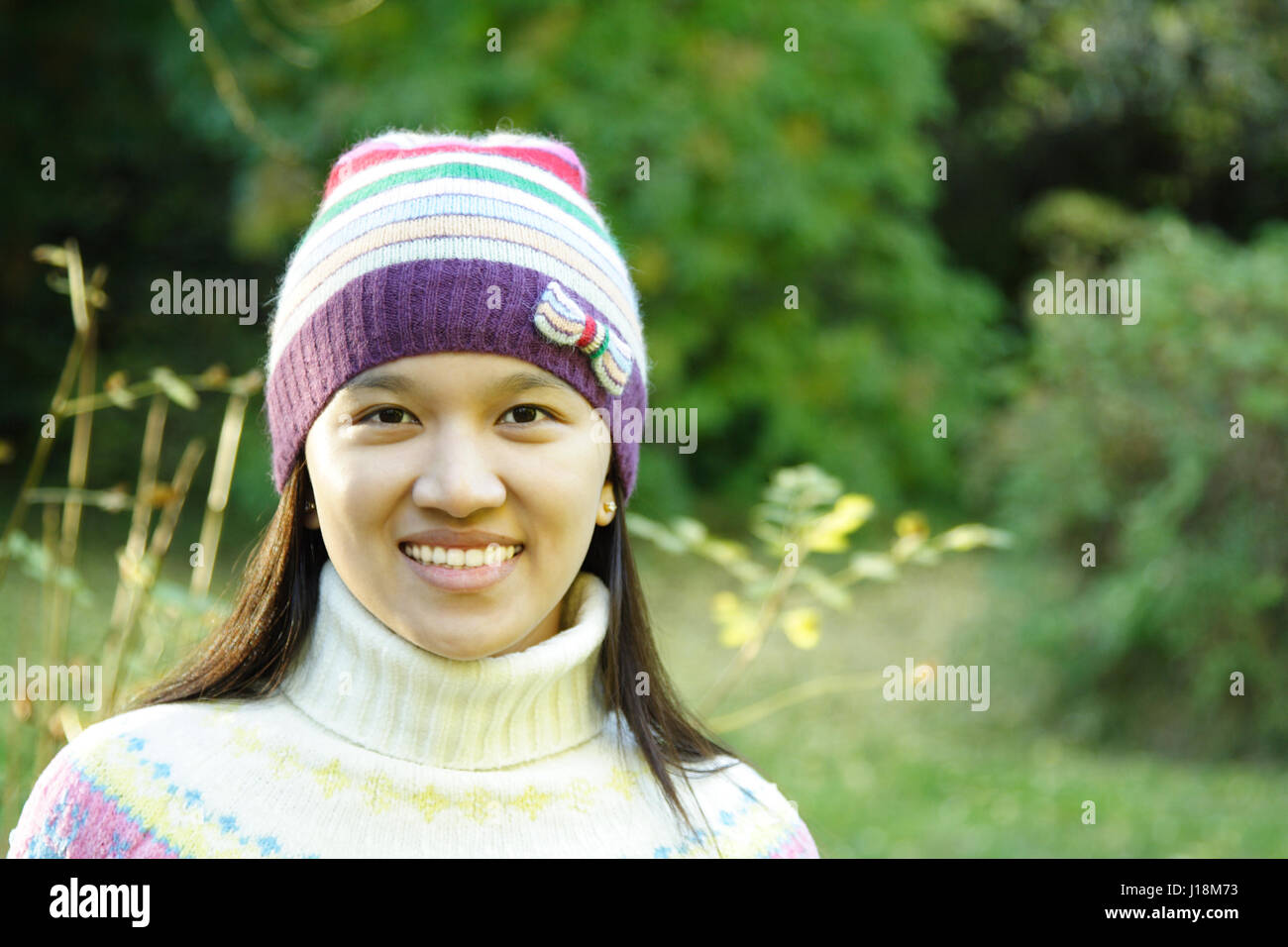 A pretty woman smiling in an outdoor setting Stock Photo - Alamy