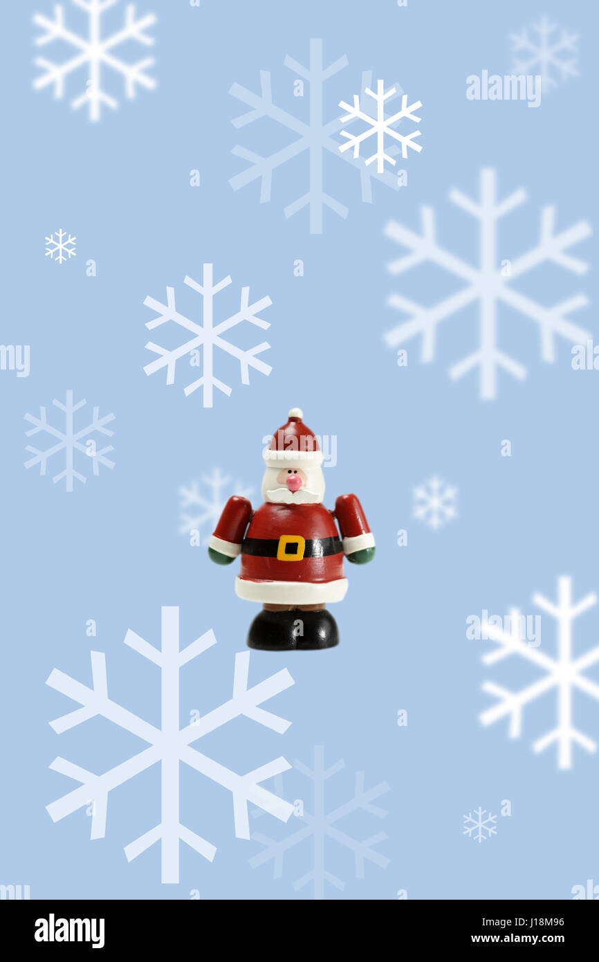 A santa claus toy with snow flakes falling down Stock Photo - Alamy