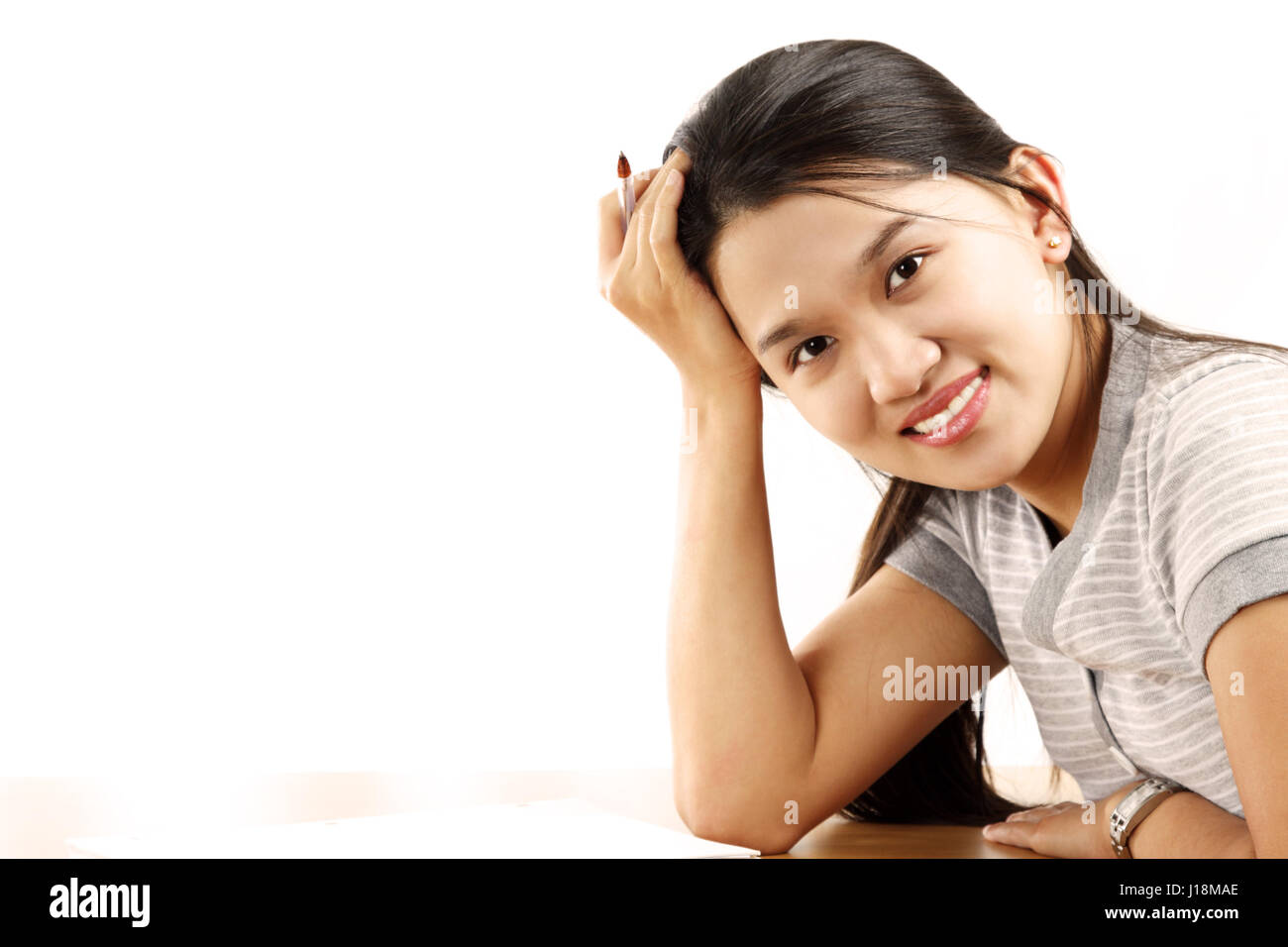 A portrait of a pretty woman smiling at her desk Stock Photo - Alamy