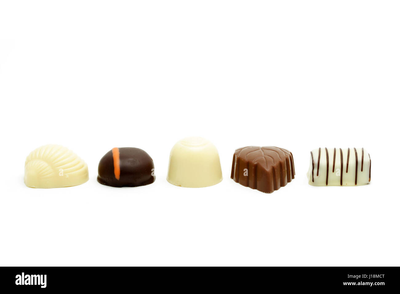 A different kind of chocolates in a row Stock Photo - Alamy