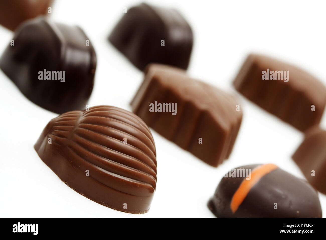 A different kind of chocolates in rows Stock Photo - Alamy