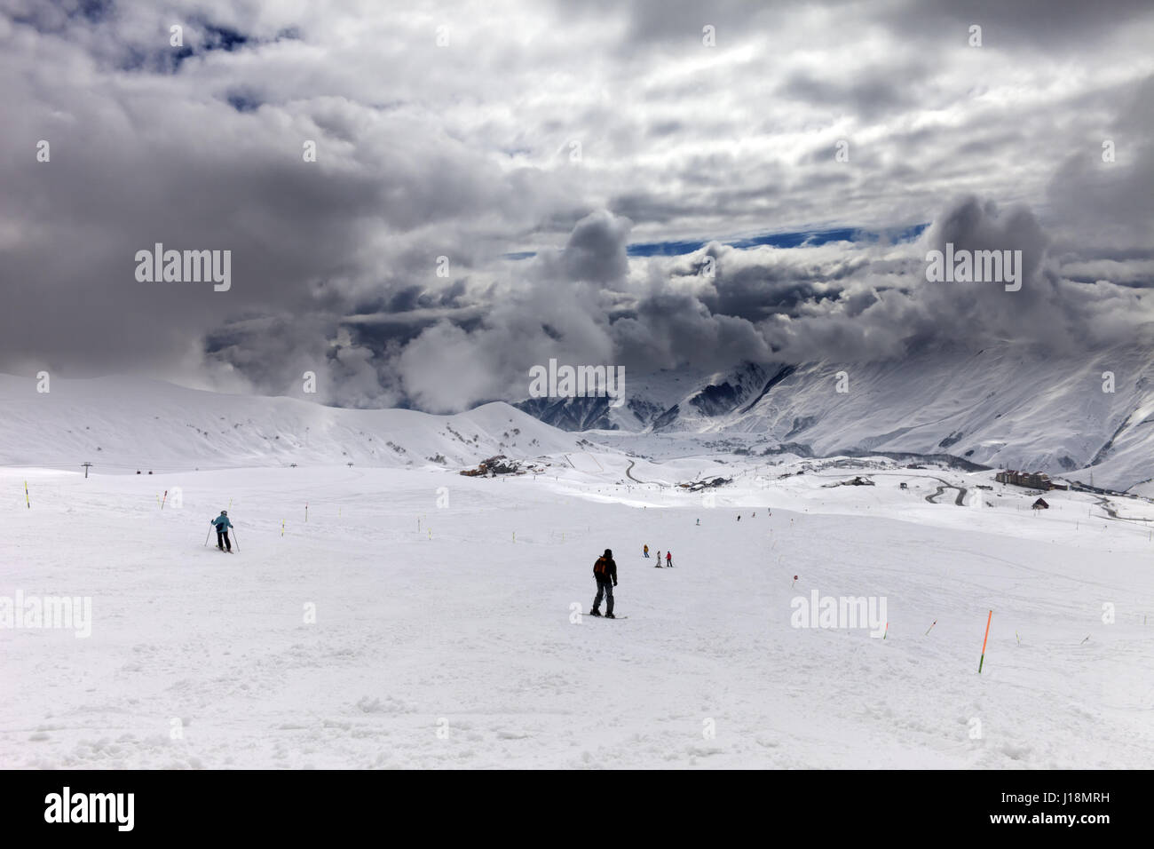 Skiers on ski slope before rain. Caucasus Mountains. Georgia, ski ...